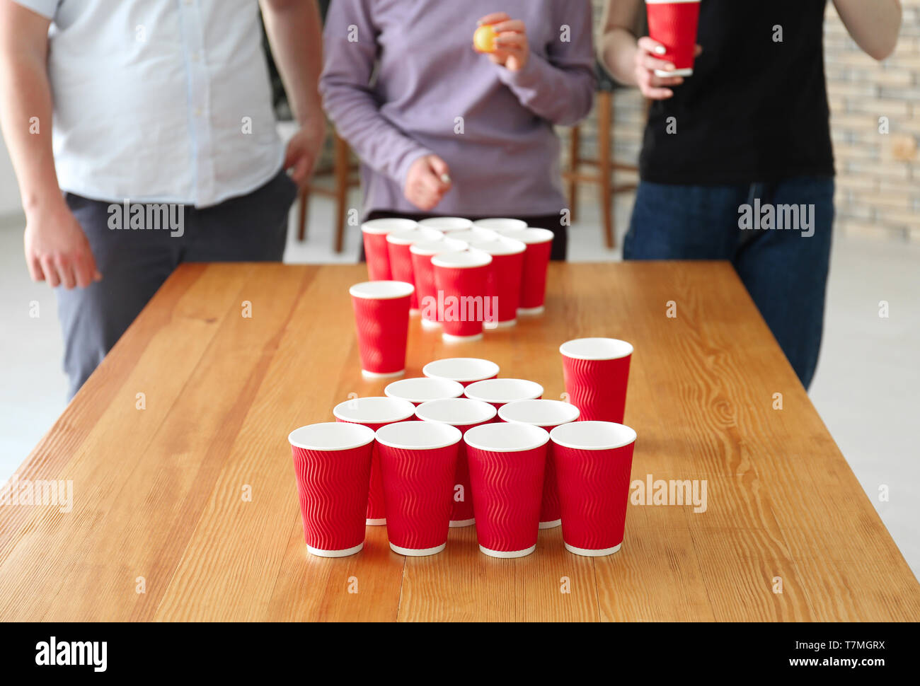 People playing beer pong in bar Stock Photo - Alamy