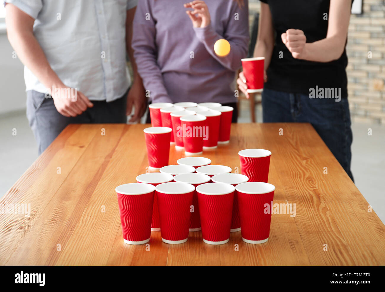 People playing beer pong in bar Stock Photo - Alamy