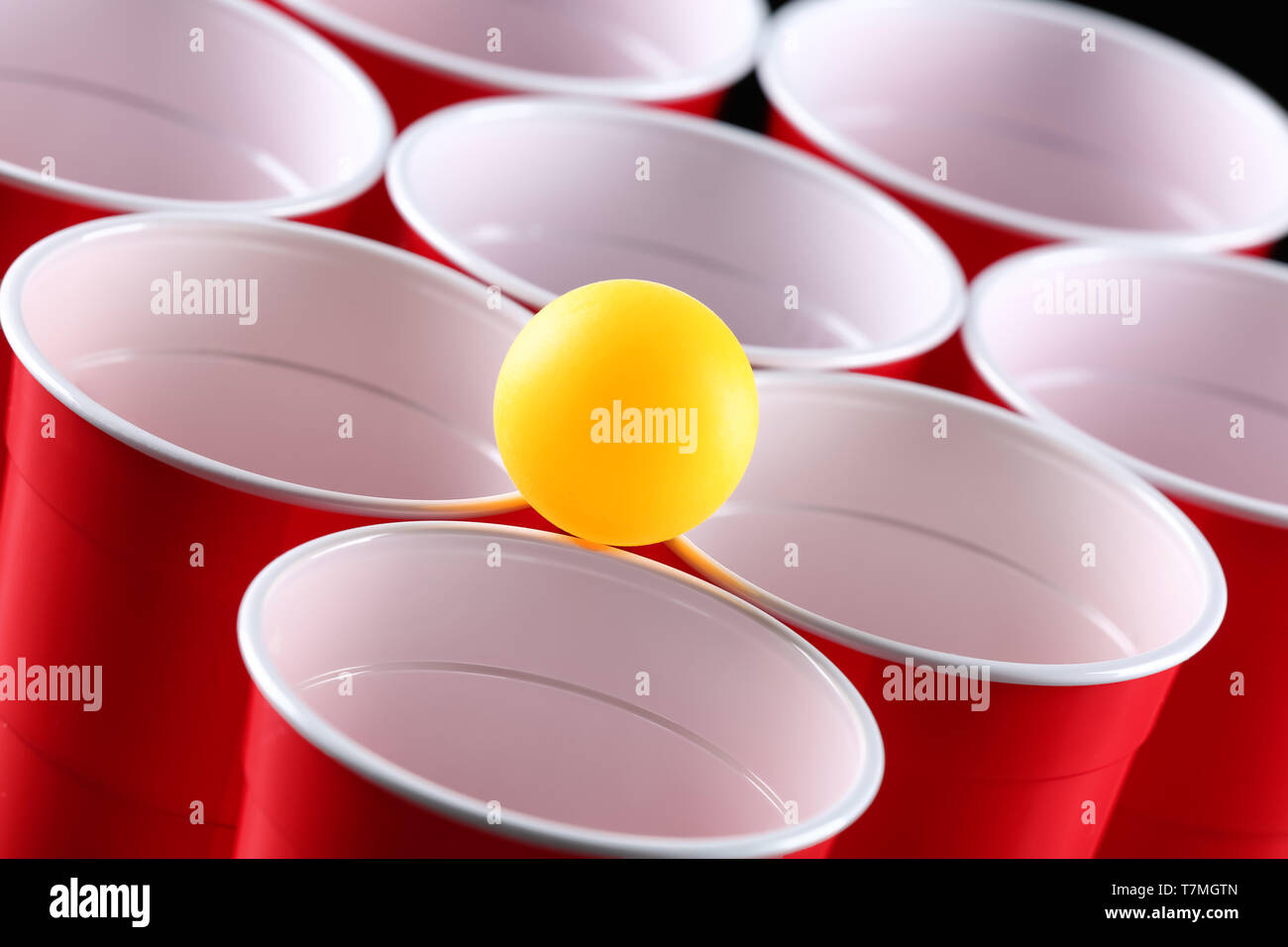 Cups and ball for beer pong, closeup Stock Photo - Alamy