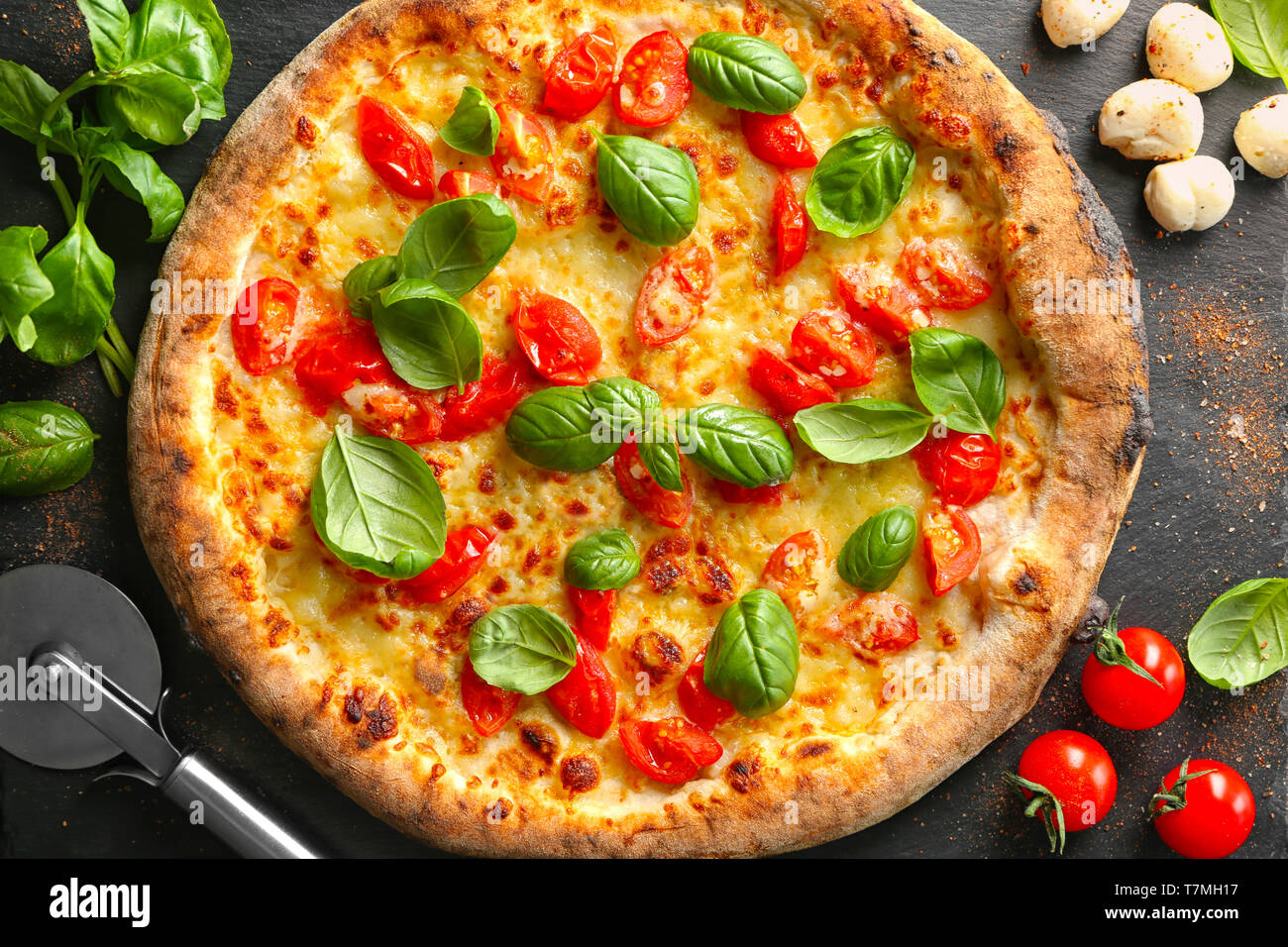 Pizza on slate with knife hi-res stock photography and images - Alamy