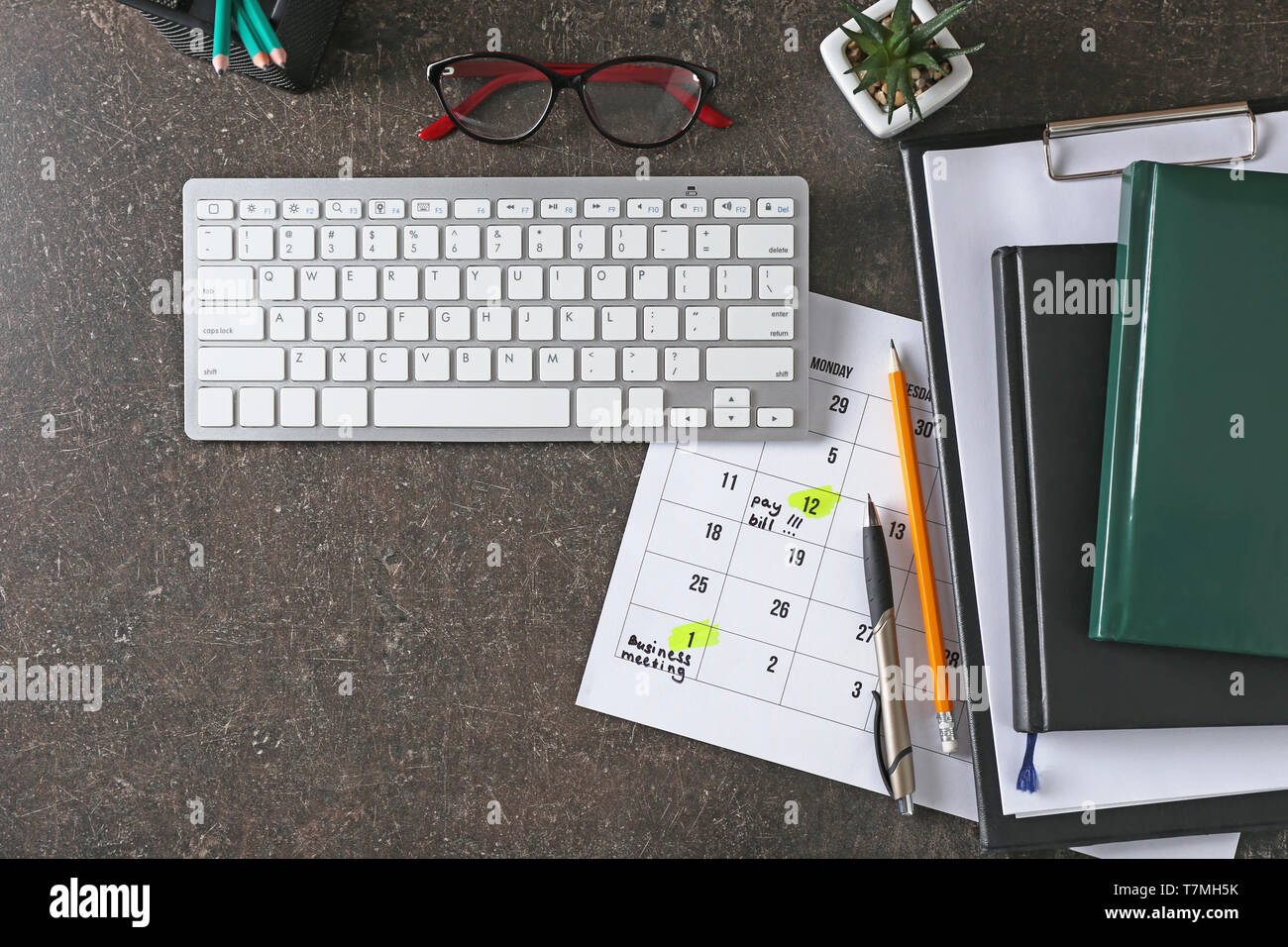 Calendar with to-do list, computer keyboard and notebooks on grey ...