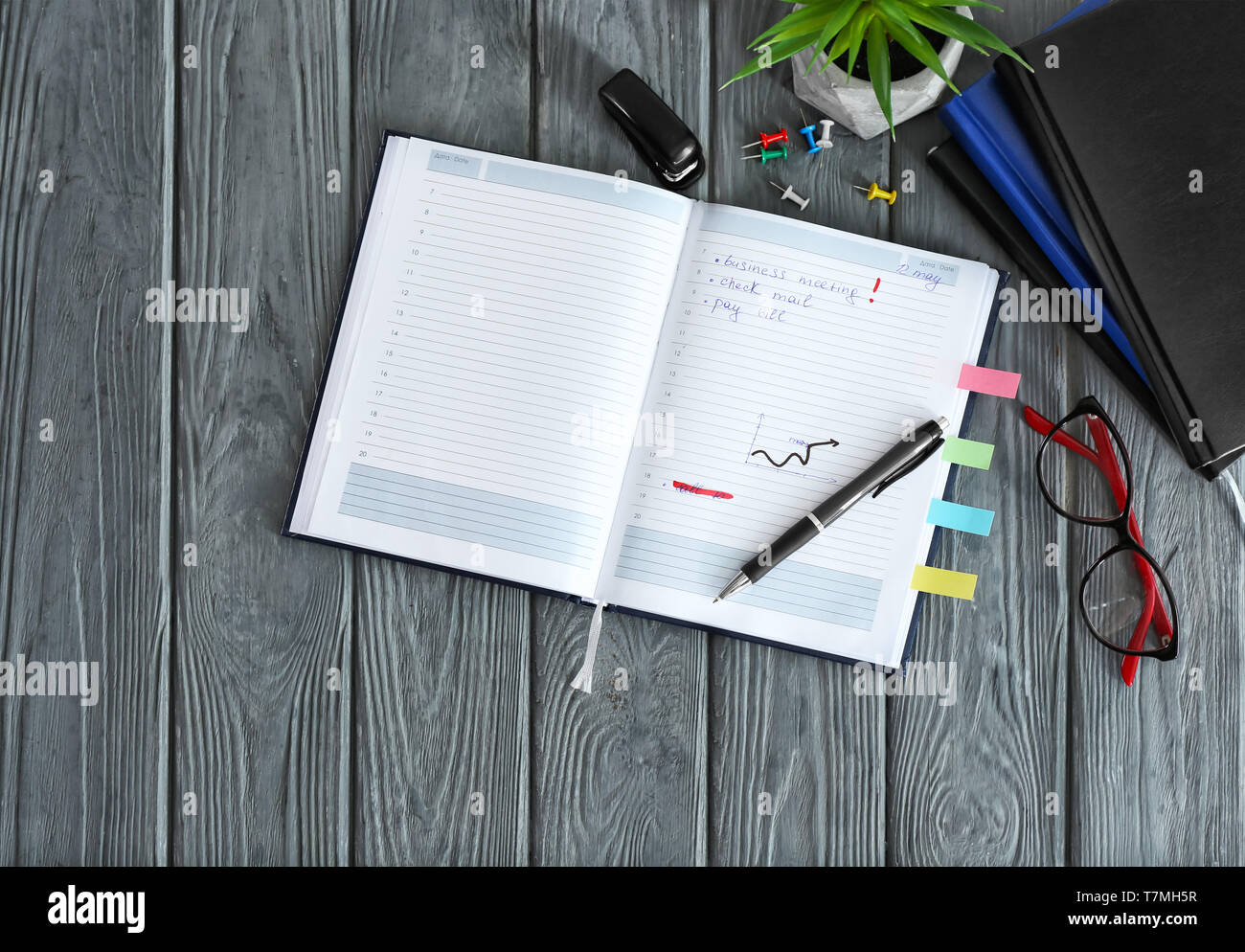To-do list with stationery on wooden background Stock Photo - Alamy