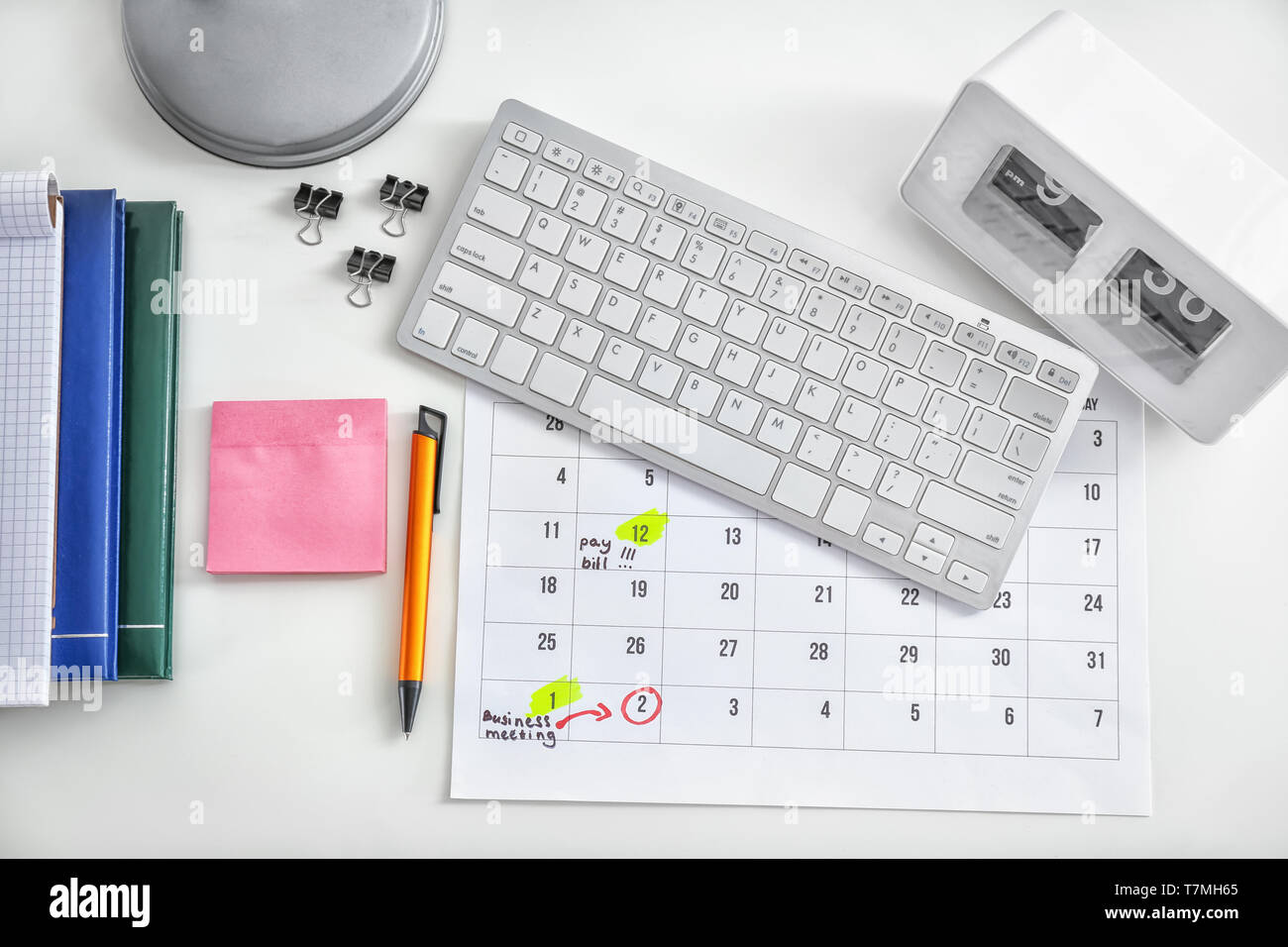 Calendar with notes, computer keyboard and stationery on white ...