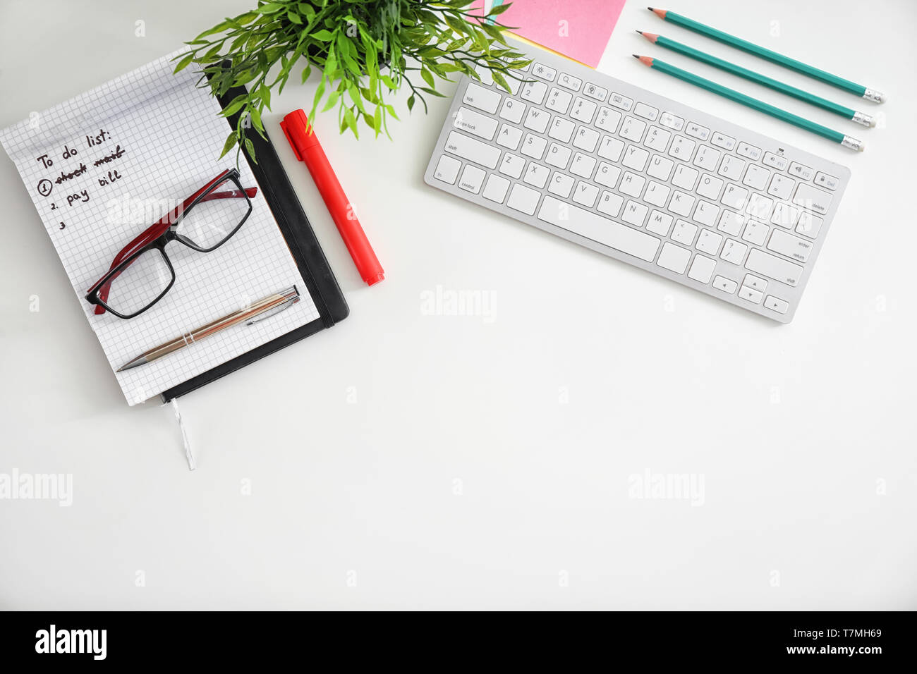 To-do list with computer keyboard and stationery on white background ...