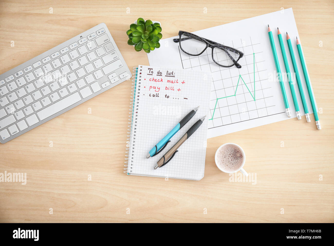 To-do list, computer keyboard and graph on wooden background Stock ...