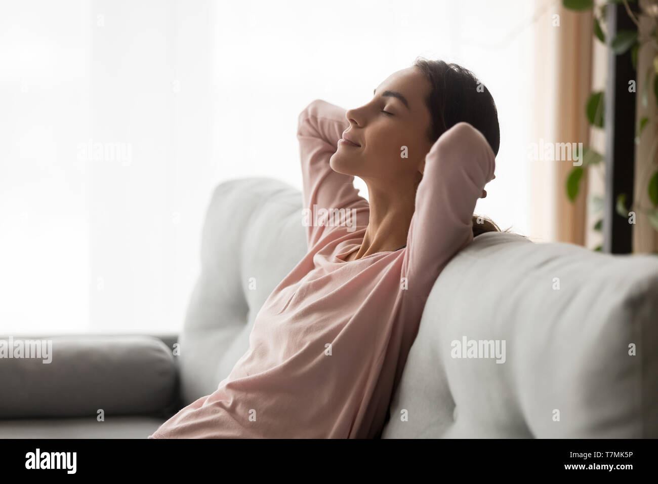 Girl leaning head on sofa hi-res stock photography and images - Alamy