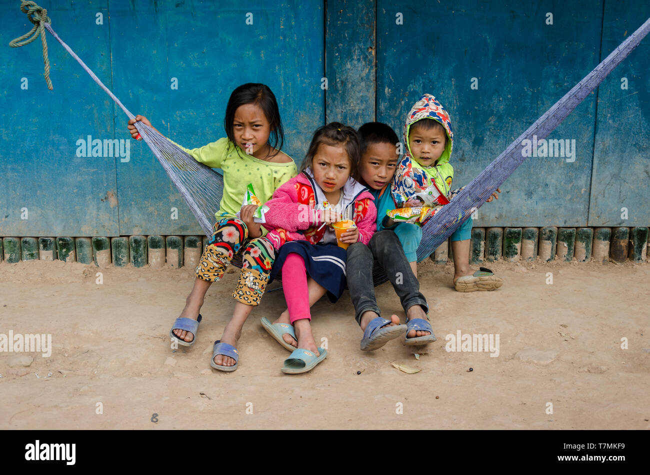 Laotian children play on their hammock, Phongsali, Laos Stock Photo - Alamy