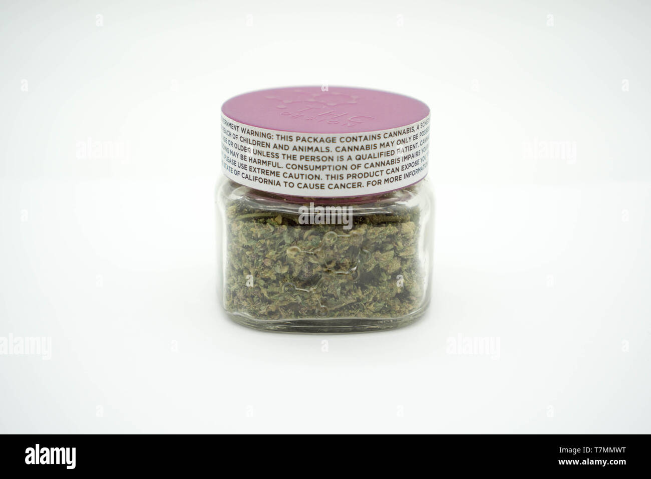 ground marijuana in a jar with warning labels Stock Photo - Alamy