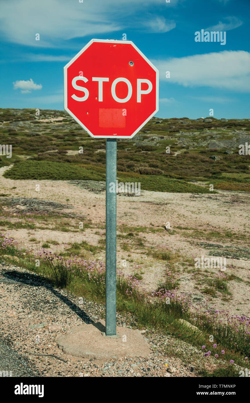 STOP traffic signpost on roadside and rocky landscape on the Serra da ...