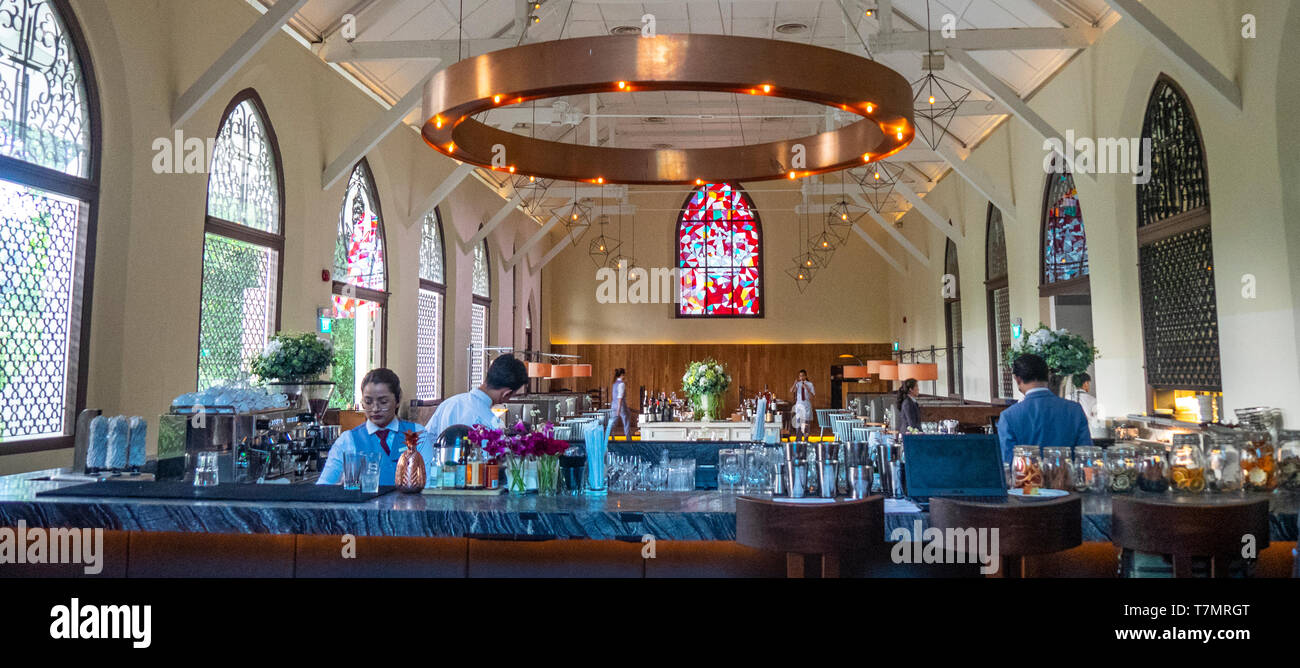 Barman at White Rabbit Restaurant in a converted church at Dempsey Hill ...