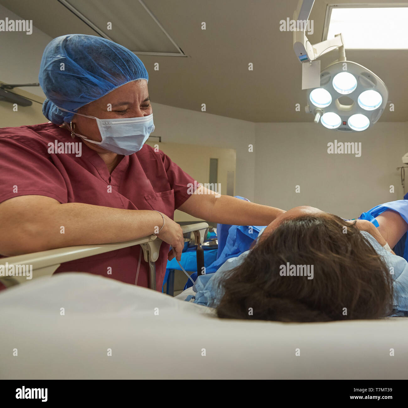 Nurse talk to patient laying on surgery table Stock Photo - Alamy