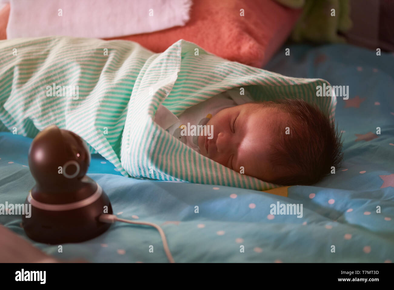 Sleeping baby under dome camera control in home bed background Stock ...