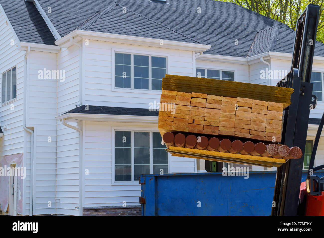 Forklift loading building materials. A stack of boards wood frame and ...