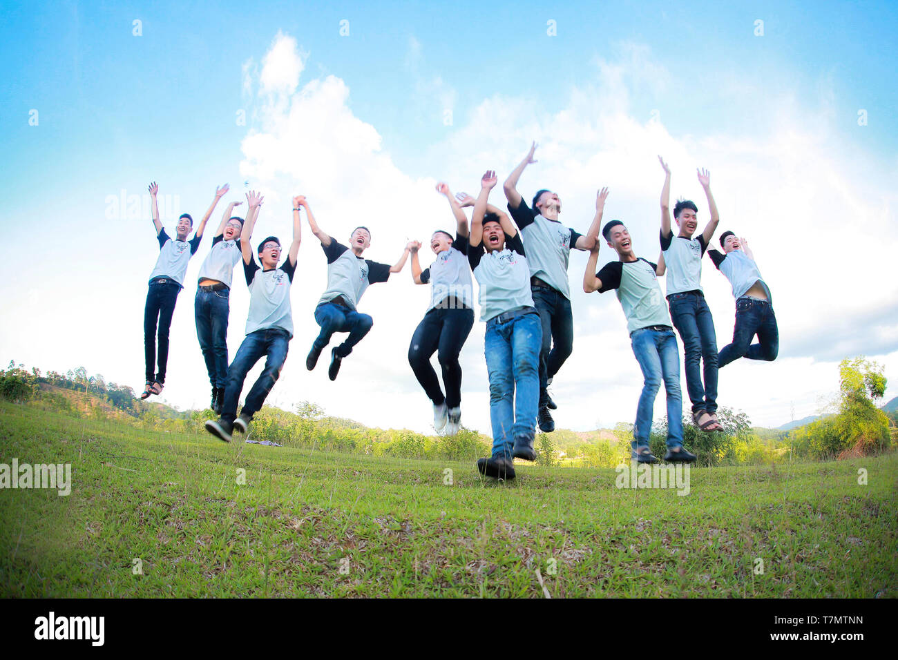 Happy friends jumping Stock Photo - Alamy
