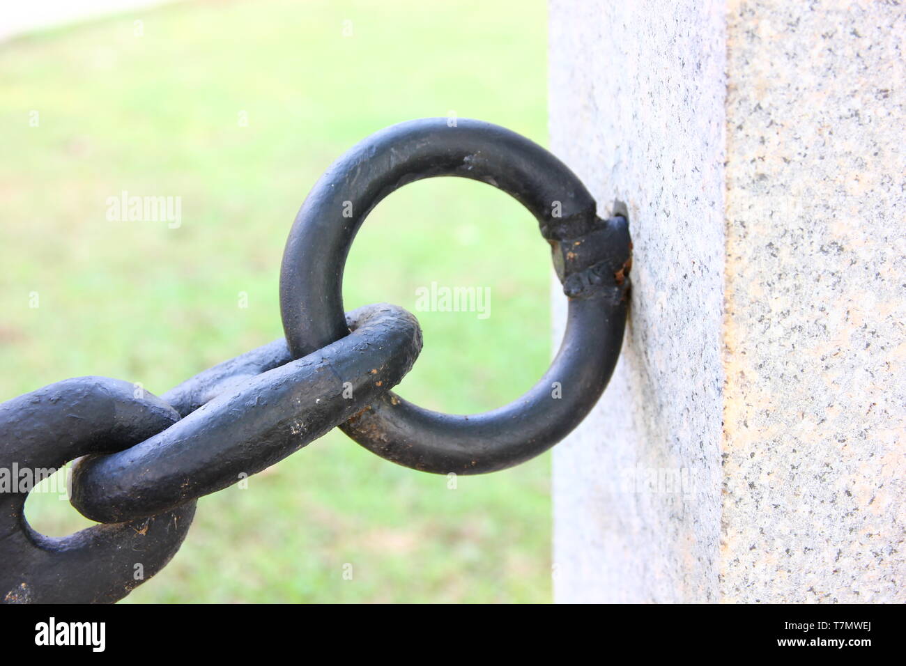 black iron chain with cement pole Stock Photo - Alamy