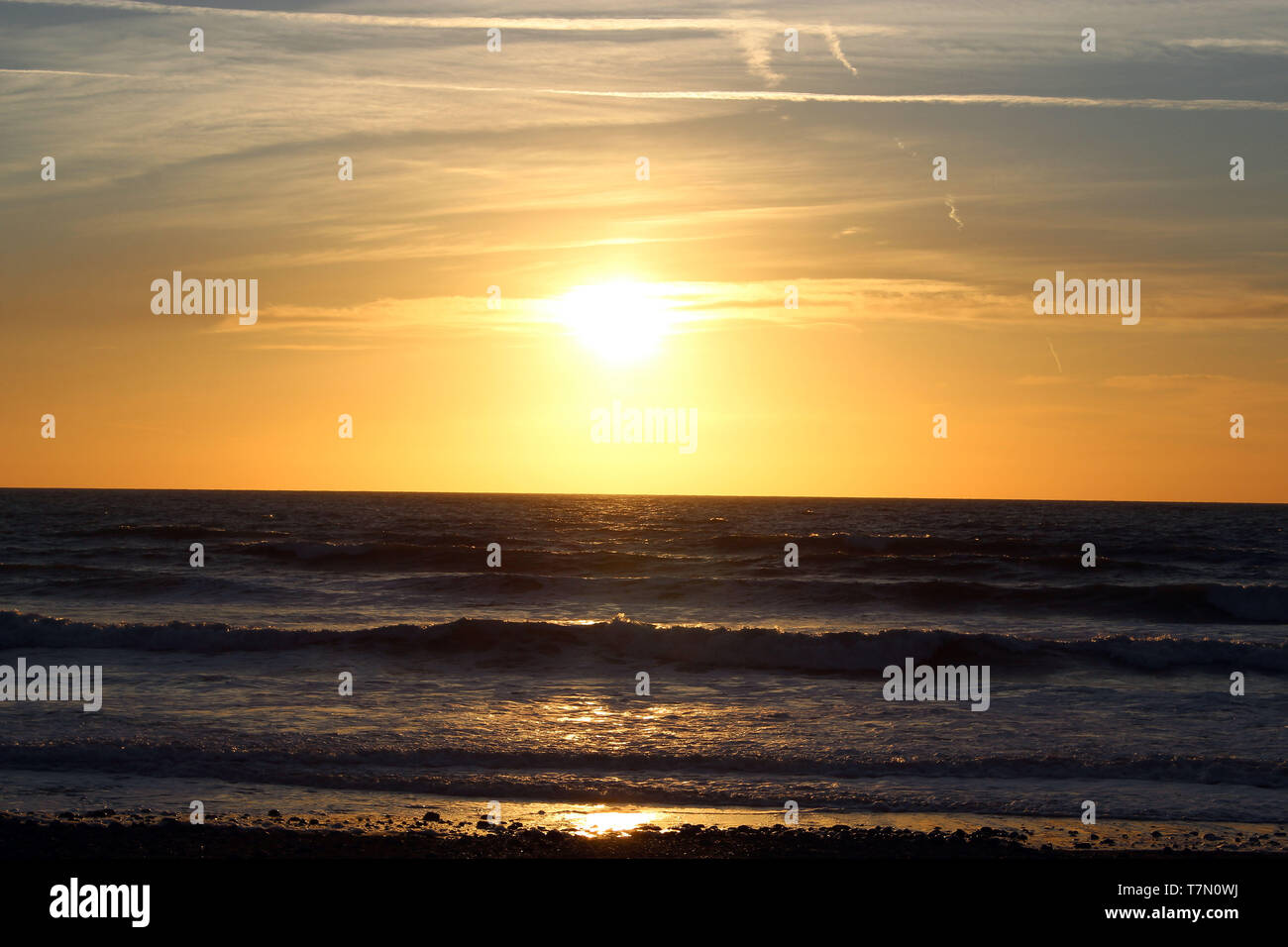 Sunset on the beach Stock Photo - Alamy