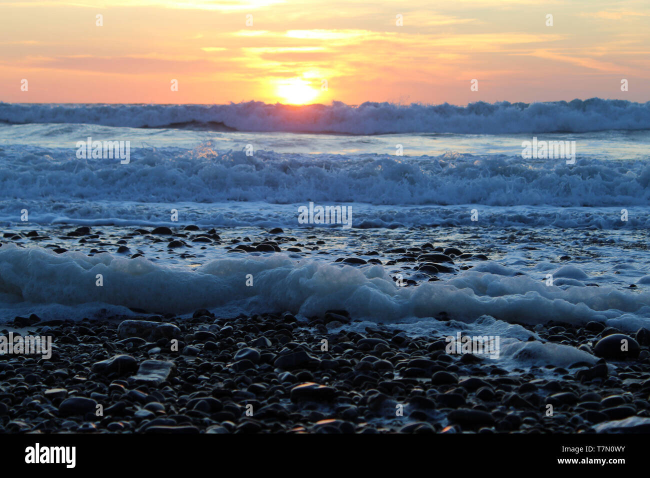 Sunset on the beach Stock Photo - Alamy