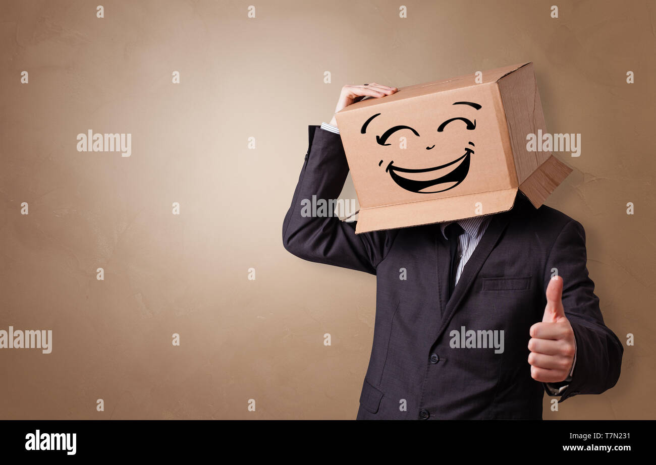 Young man with happy face illustrated cardboard box on his head Stock ...