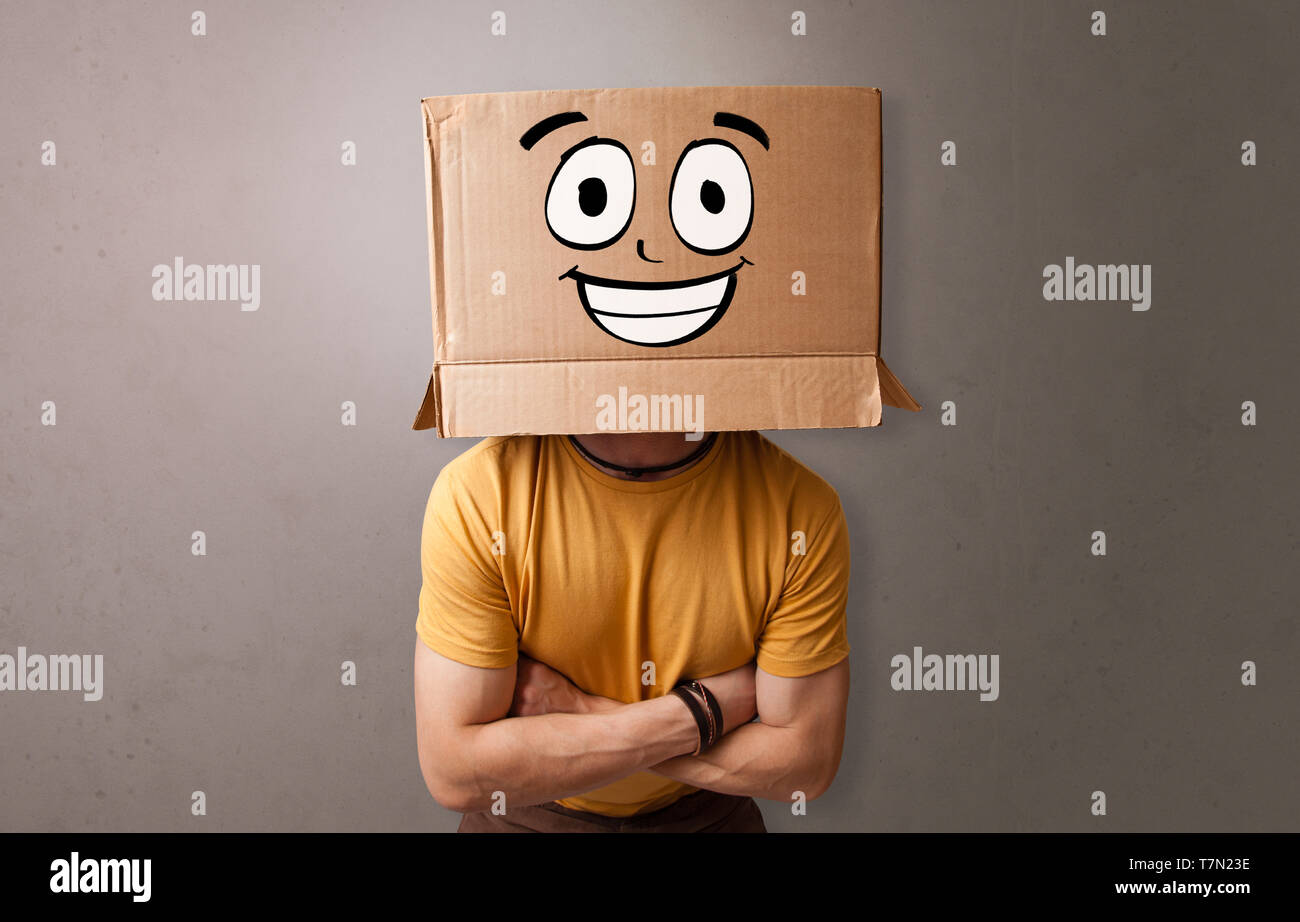 Young boy standing and gesturing with a cardboard box on his head Stock ...