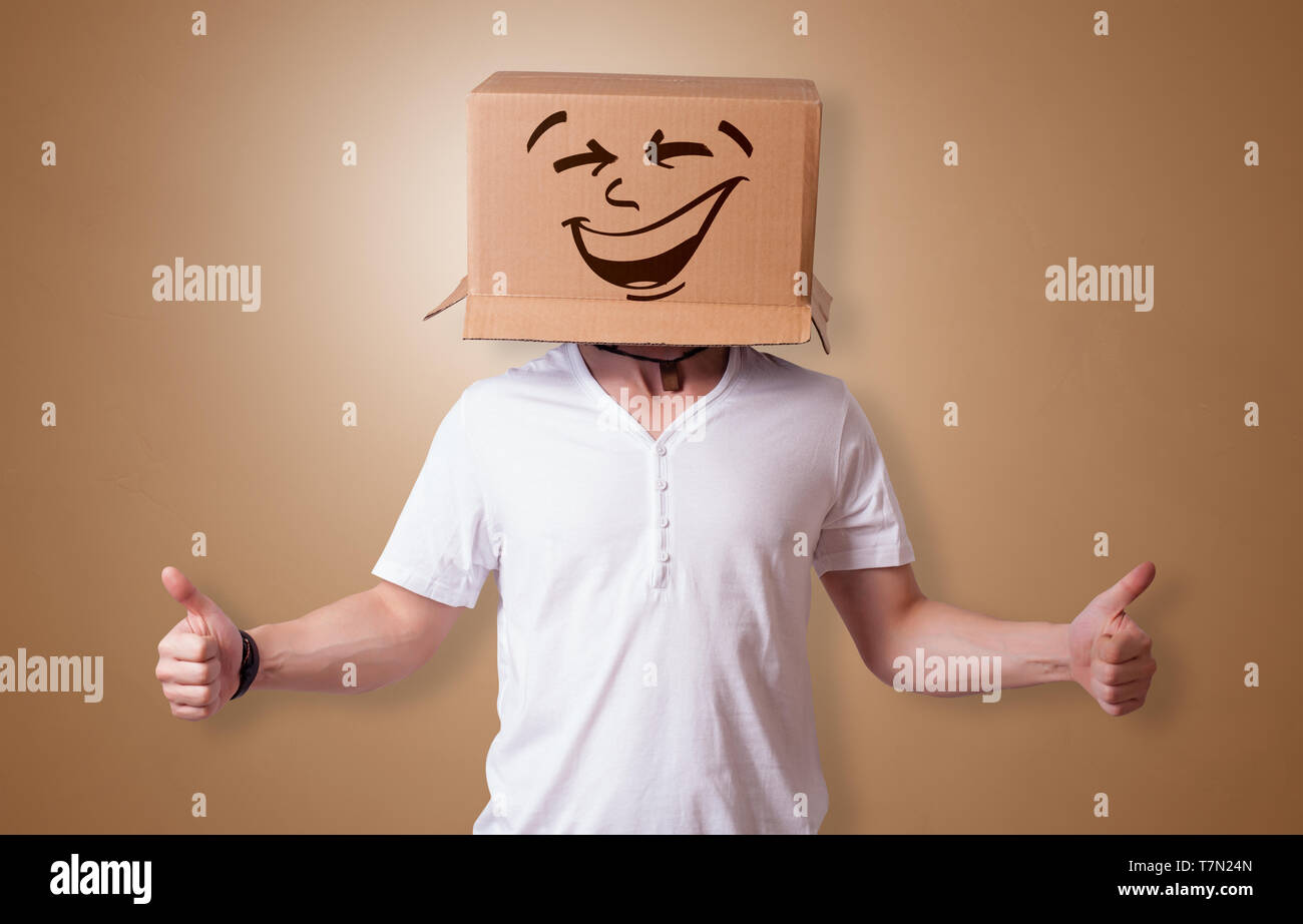 Young boy standing and gesturing with a cardboard box on his head Stock ...