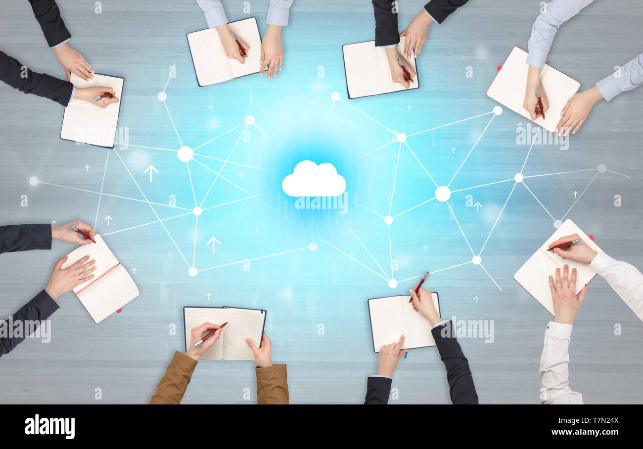 Group of people with devices in hands working in team on tablets ...