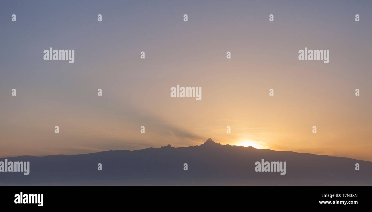 Early morning, sun rising over the shoulder of Mount Kenya, wide ...