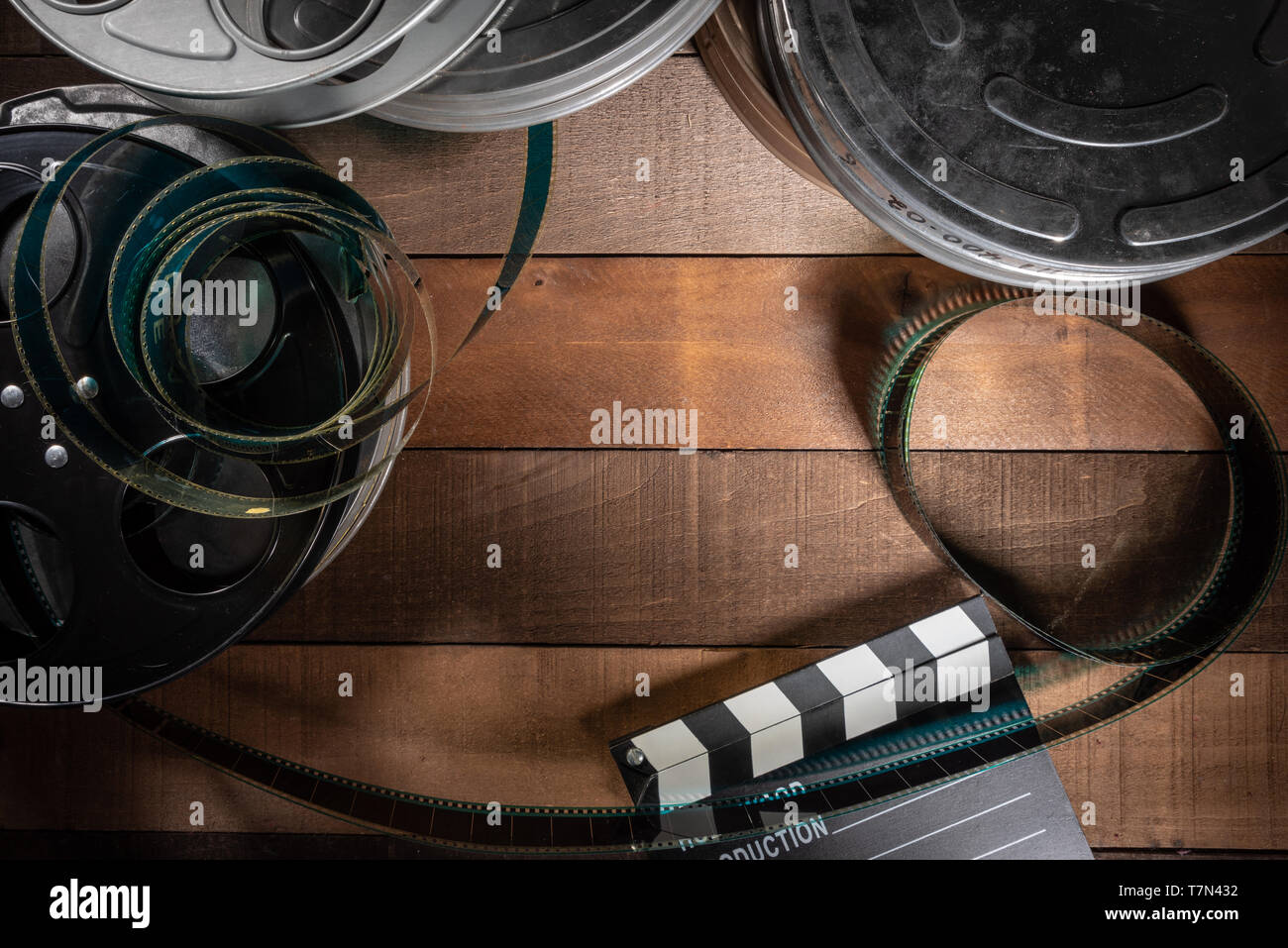 Multiple film reels and a clapboard on a wooden background. Film ...