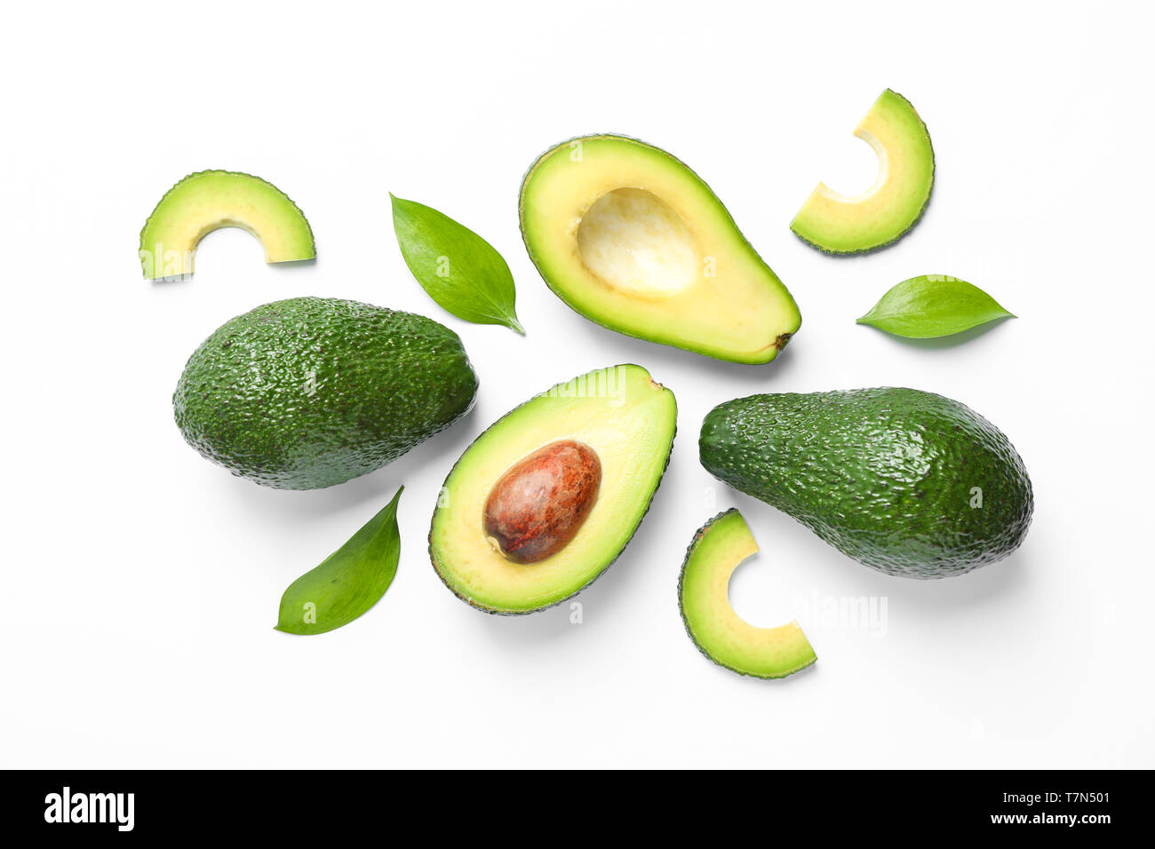 Flat lay composition with ripe avocados and leaves on white background ...