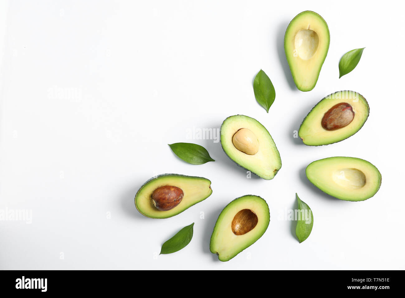 Flat lay composition with ripe avocados on white background, space for ...