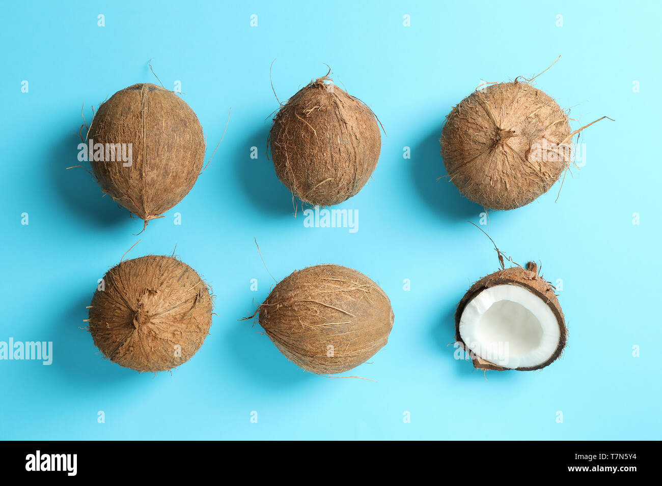 Flat lay composition with coconuts on color background Stock Photo - Alamy