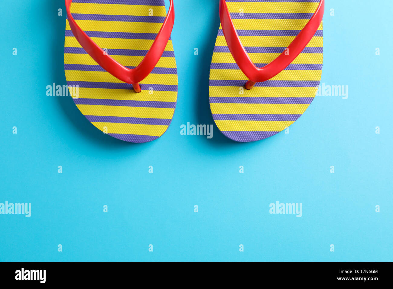 Flip flops on color background, space for text. Summer vacation ...