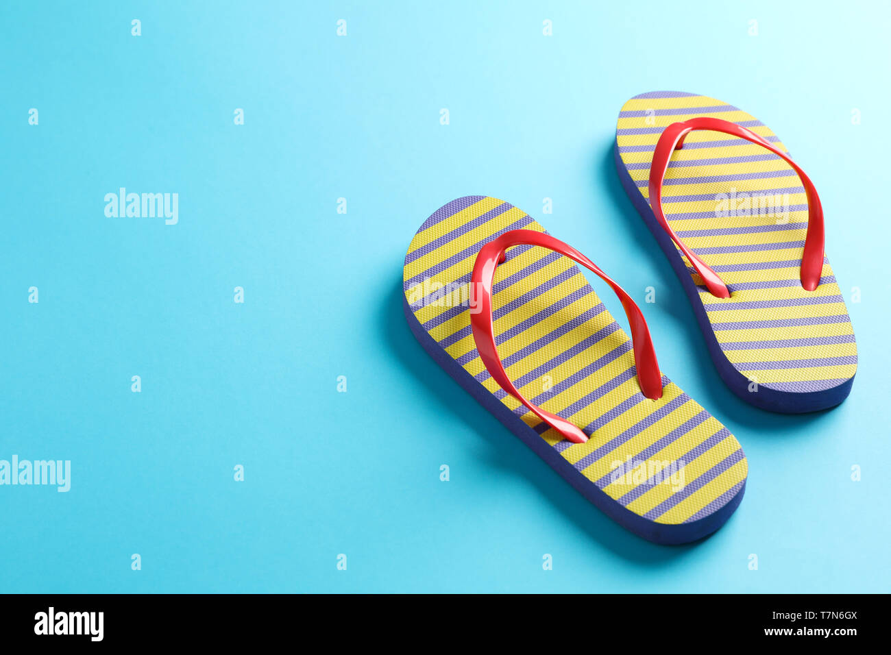Flip flops on color background, space for text. Summer vacation ...