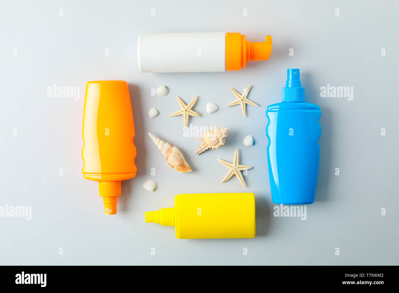 Flat lay composition with sunscreen sprays and starfishes on color ...