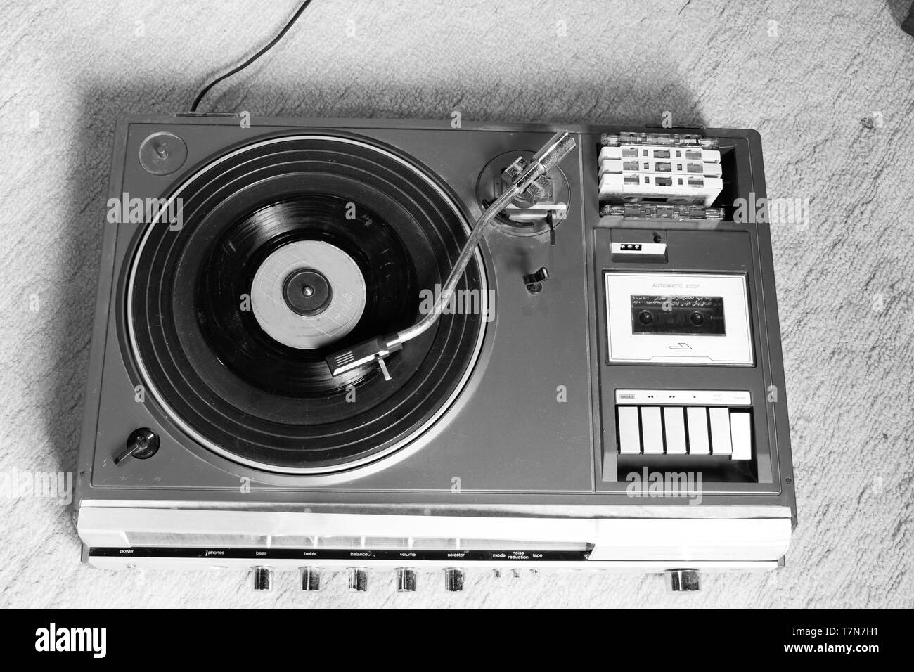This is and old and antique turntable captured in black and white and ...