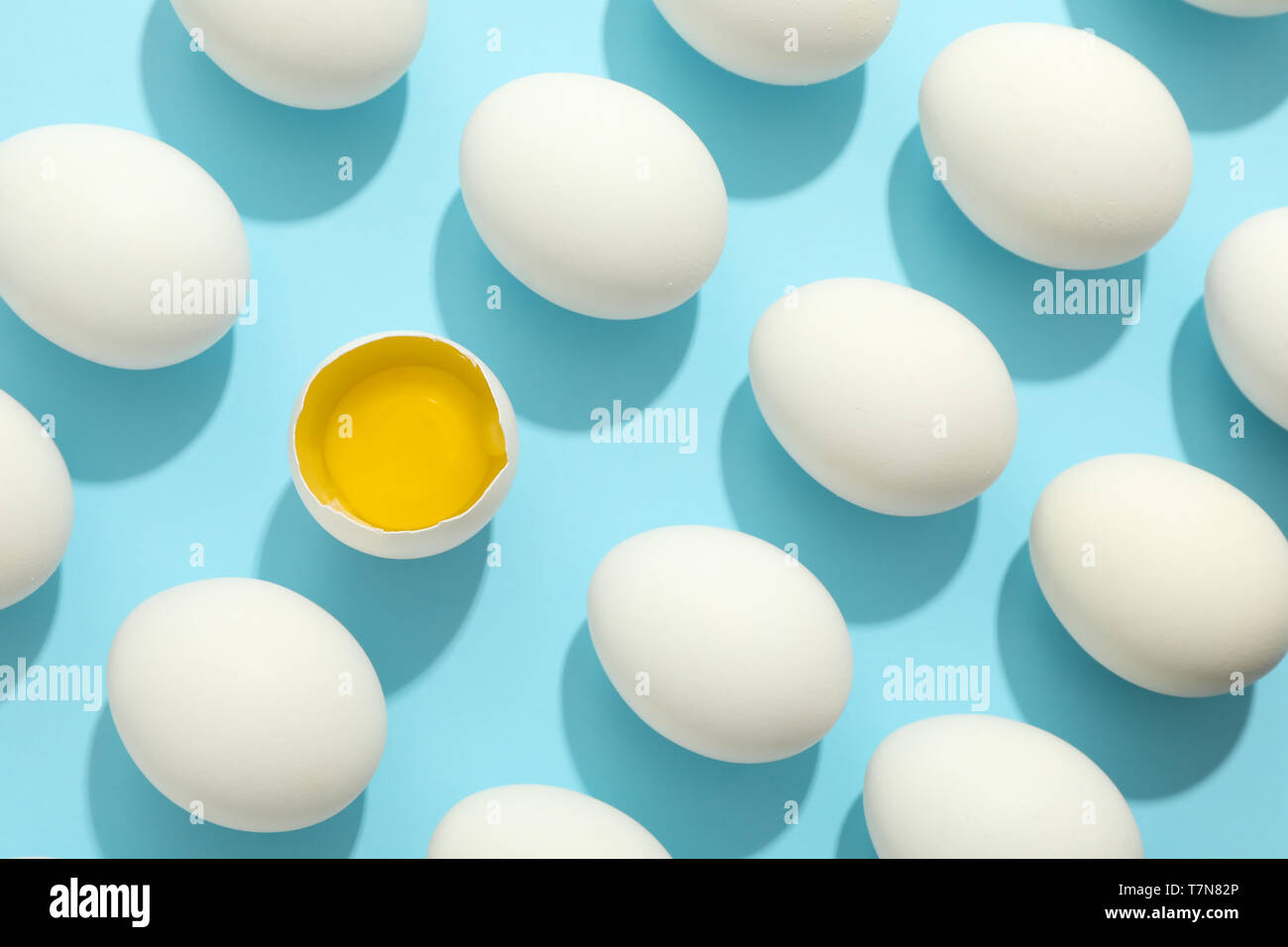 Flat lay composition with chicken eggs and half with yolk on color ...