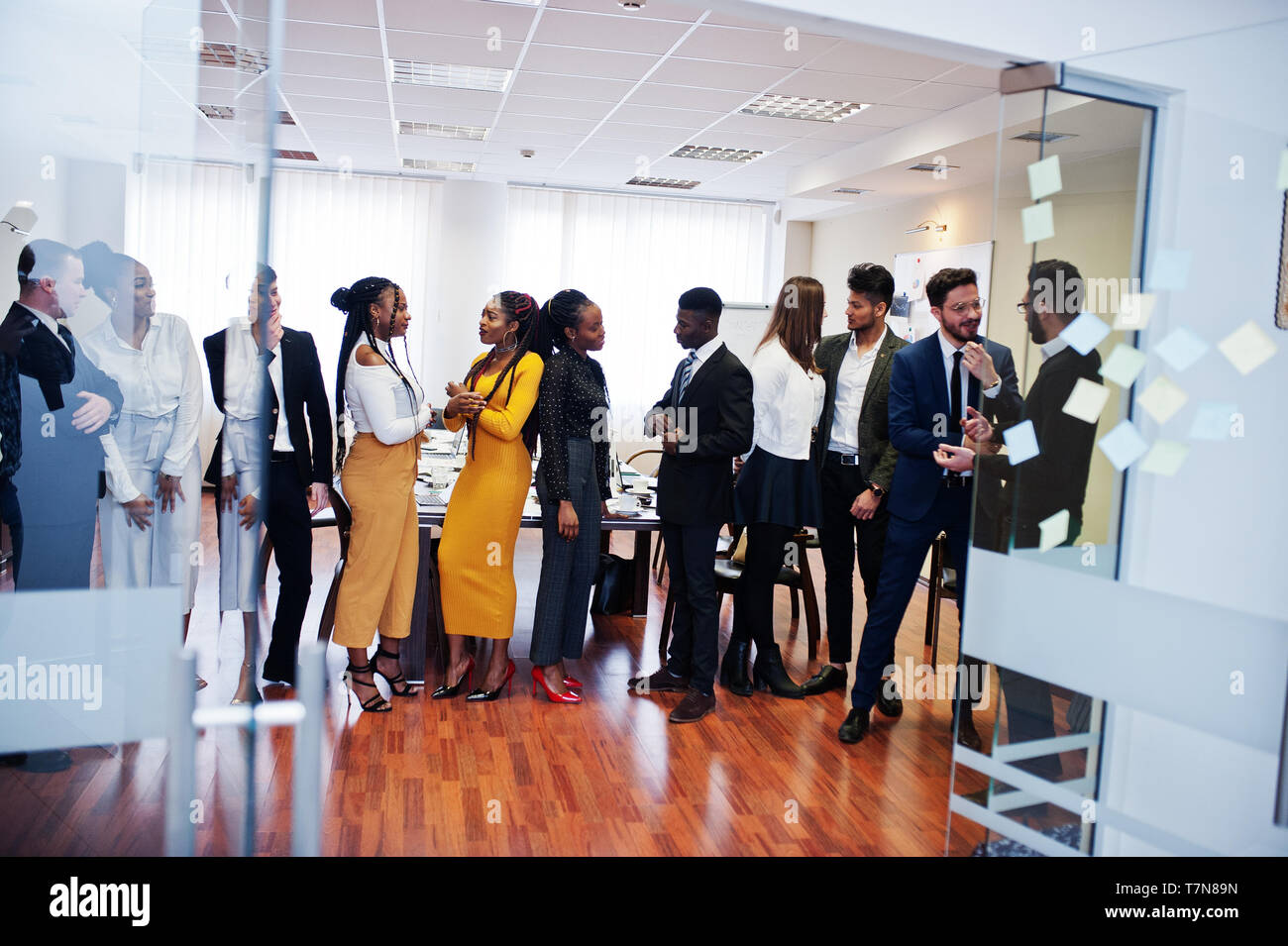 Large group of eleven multiracial business people standing at office ...