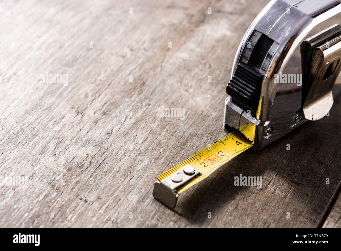 Measuring tape on wooden table Stock Photo - Alamy