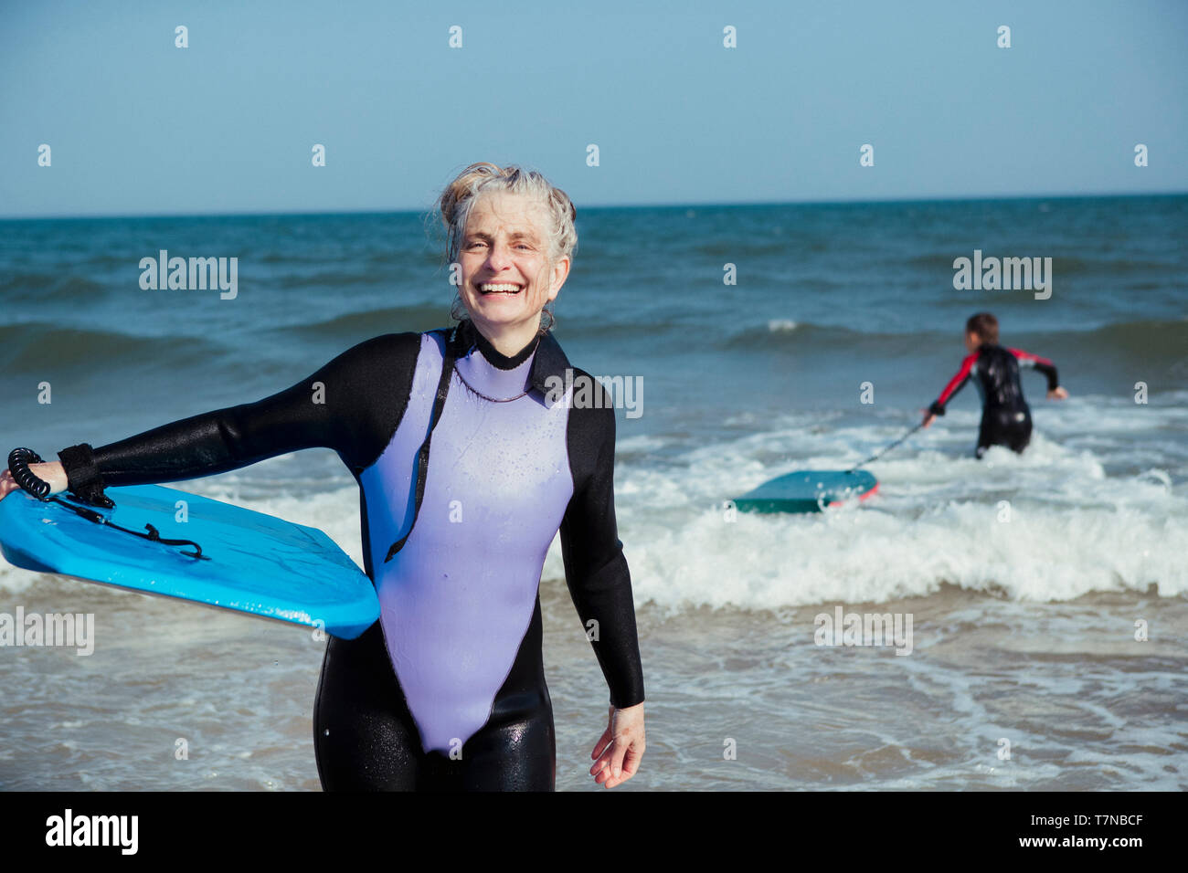 Portrait of a mature bodyboarder on the beach after being in the sea ...