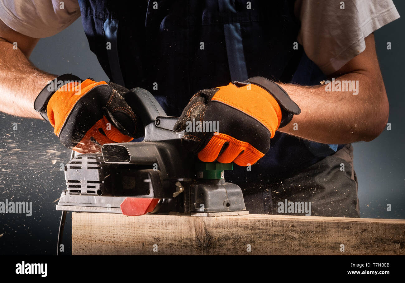 Carpenter works with electrical planer hi-res stock photography and ...