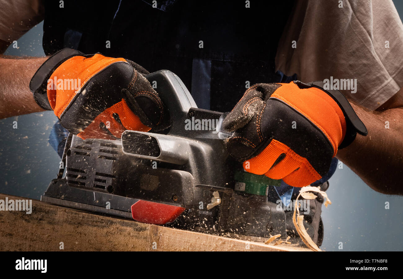 Carpenter works with electrical planer hi-res stock photography and ...