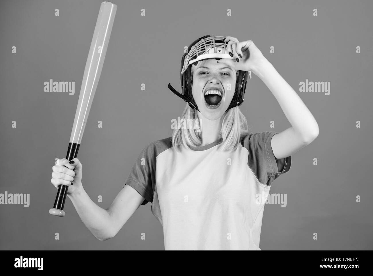 Girl confident pretty blonde wear baseball helmet and hold bat on blue ...
