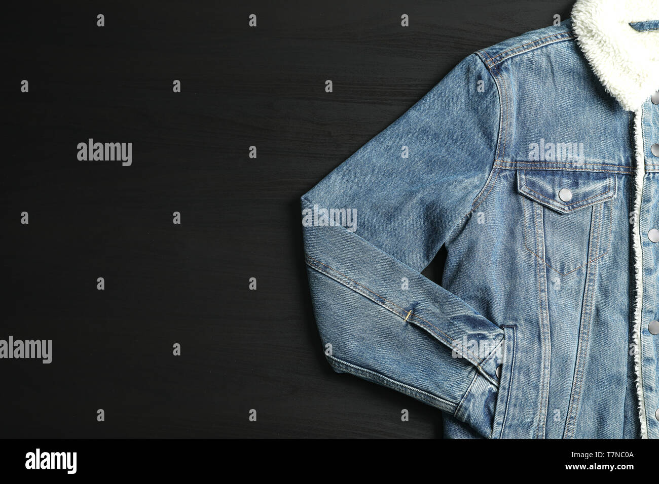 Denim jacket on black background, space for text Stock Photo - Alamy