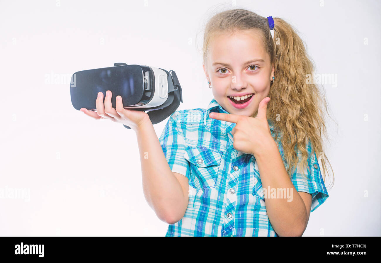 Little girl wearing virtual reality goggles. Little child in VR headset ...