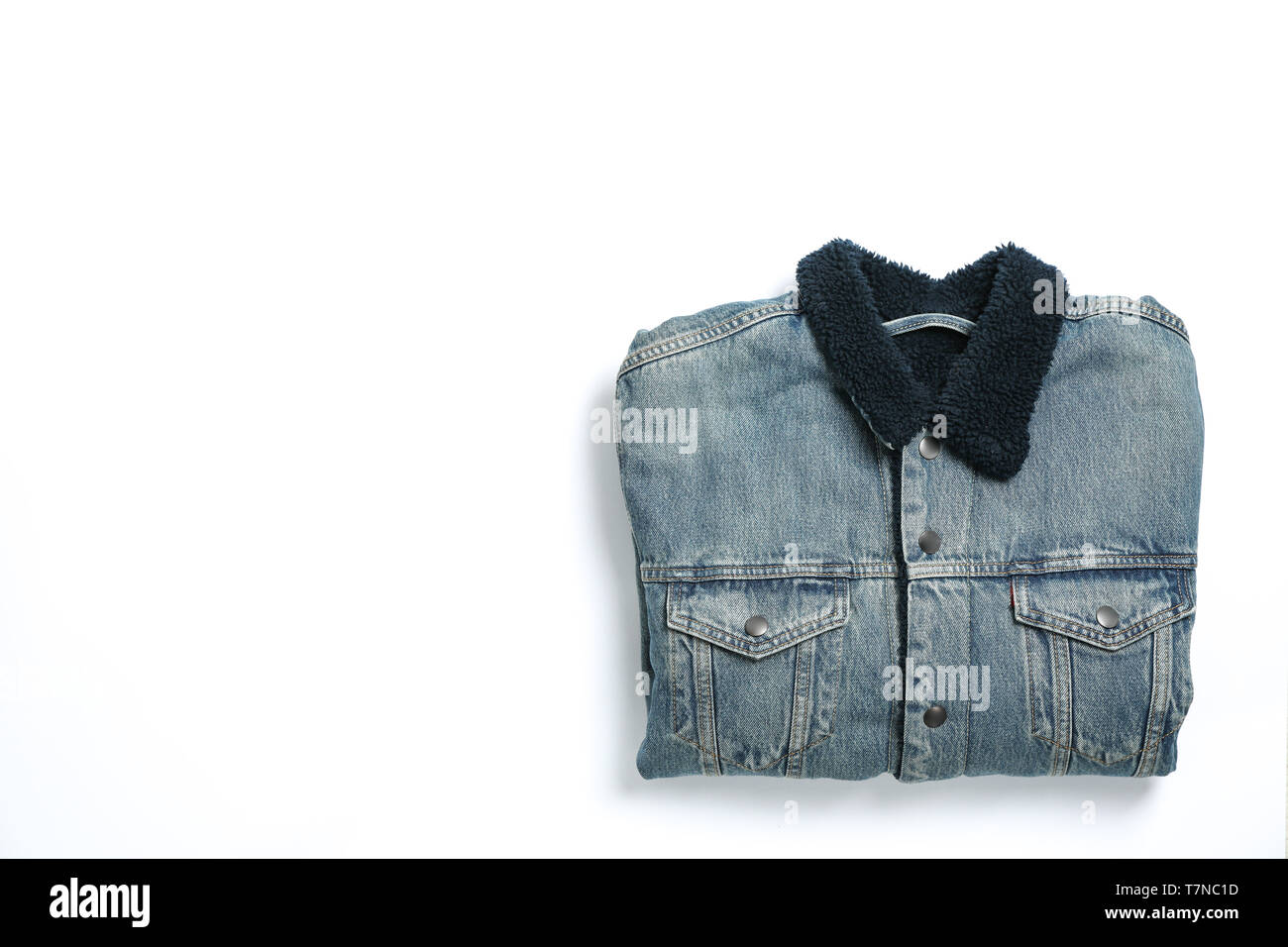Folded denim jacket on white background, space for text Stock Photo - Alamy