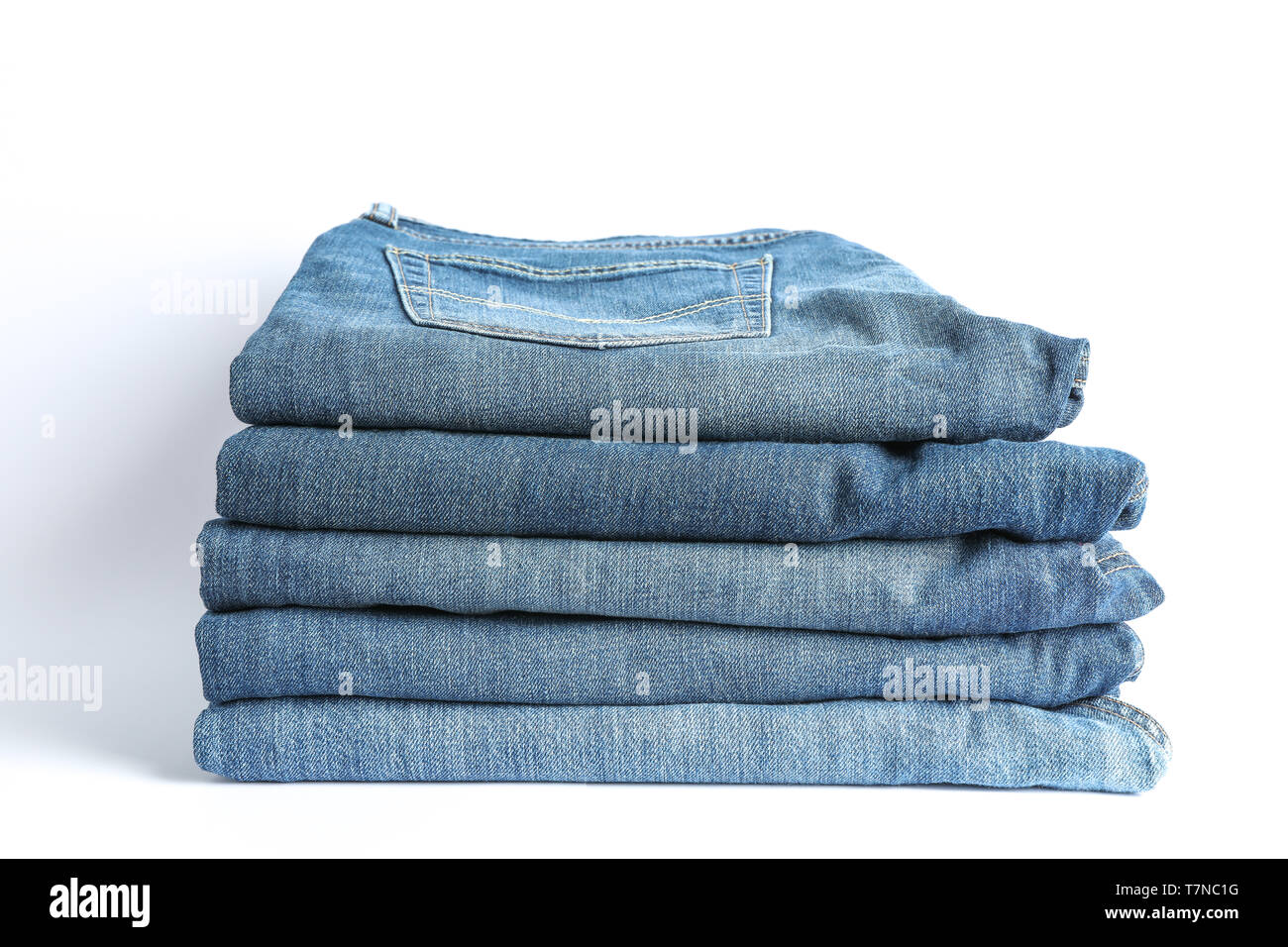 Stack of blue jeans on white background, space for text Stock Photo - Alamy