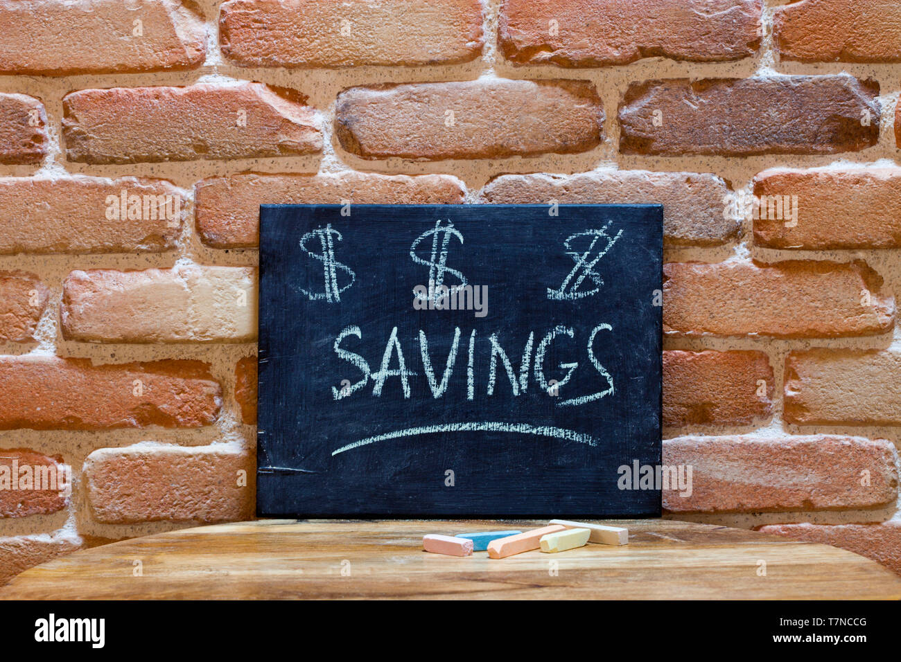 Black board with the word "Savings" drown by hand on wooden table on ...