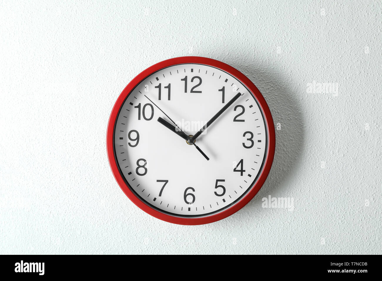 Big beautiful clock hanging on light background, space for text Stock Photo - Alamy