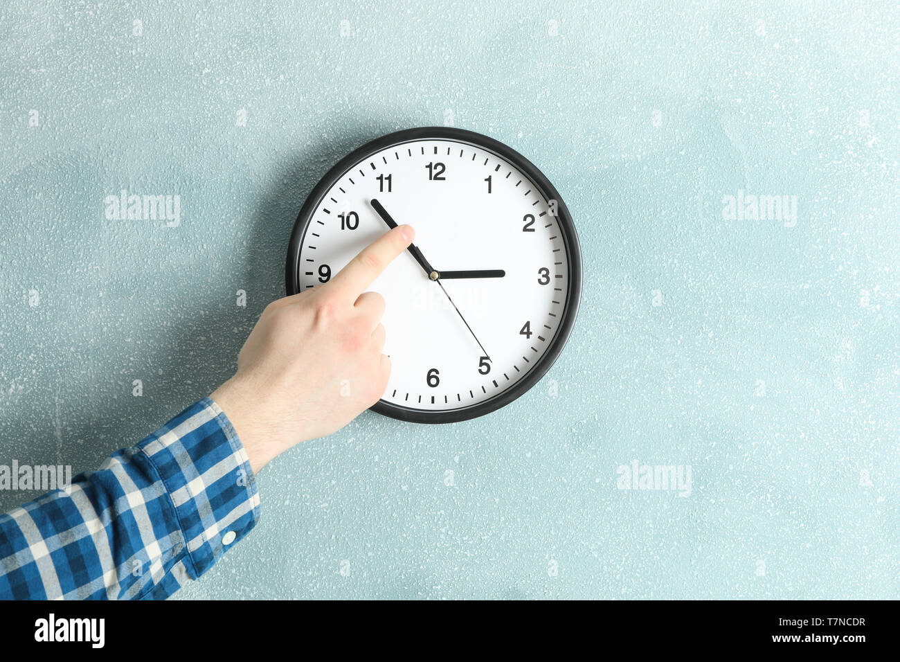 Man hanging on hour hand hi-res stock photography and images - Alamy