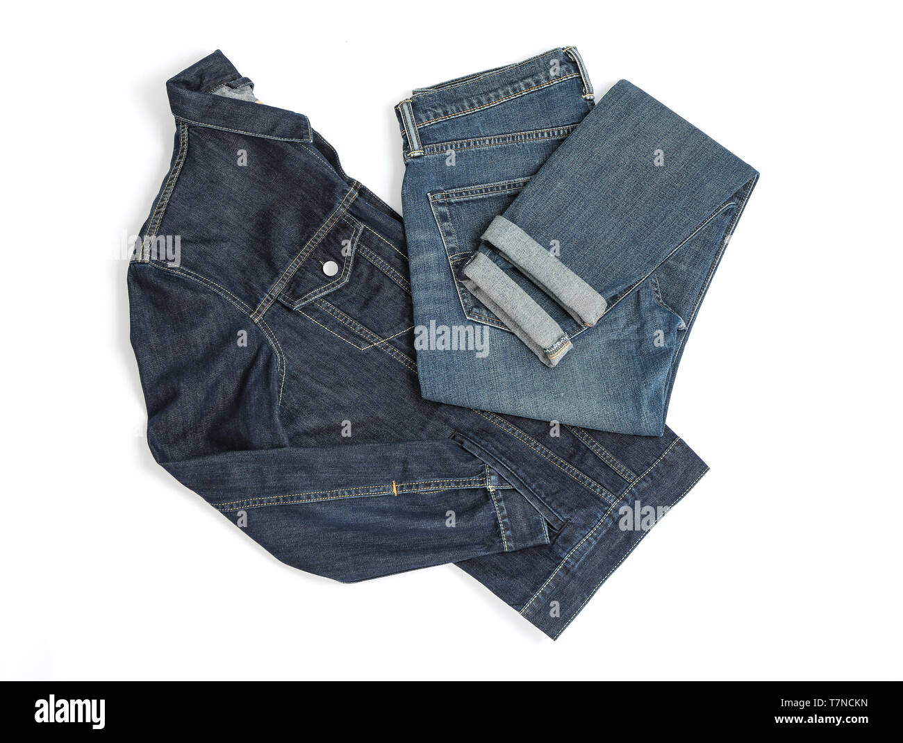 Folded denim jacket and jeans on white background Stock Photo - Alamy