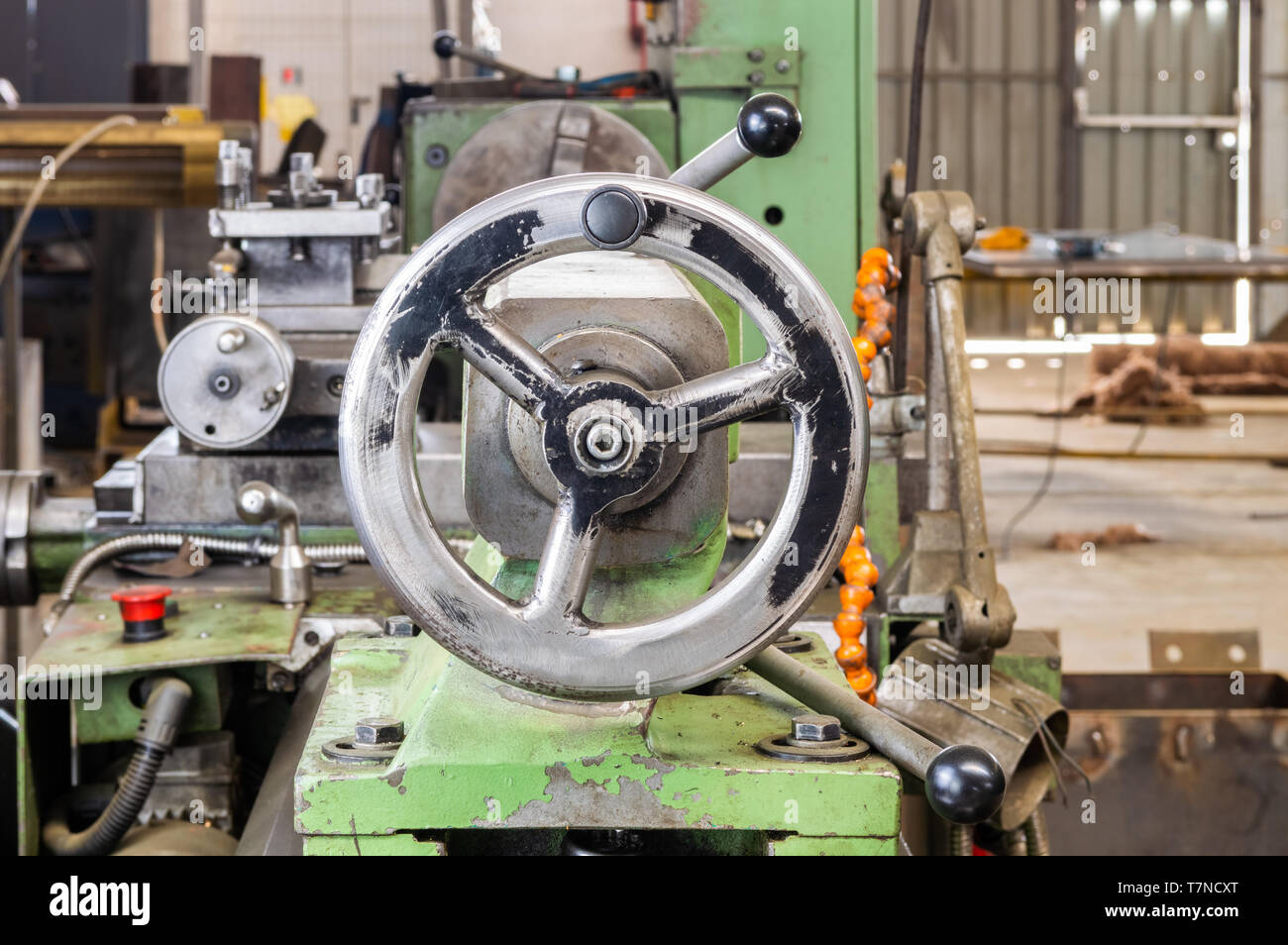 Front view of a crank wheel on industrial lathe machine in a factory ...